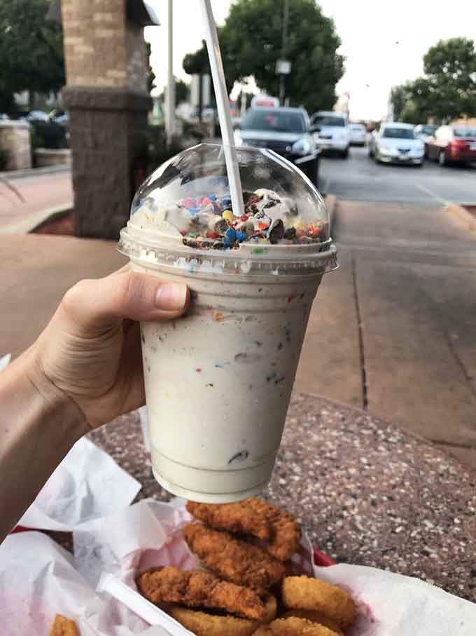 A milkshake topped with enough sprinkles to make a unicorn jealous and your inner child absolutely ecstatic.