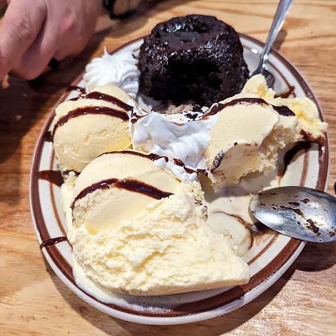 That warm brownie paired with vanilla ice cream and chocolate drizzle is pure nostalgic comfort.