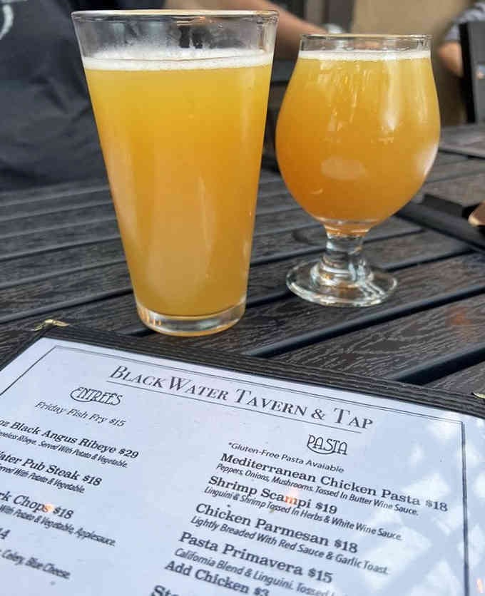 Cold craft brews catching the light remind you that great food deserves equally impressive beverage pairings throughout.