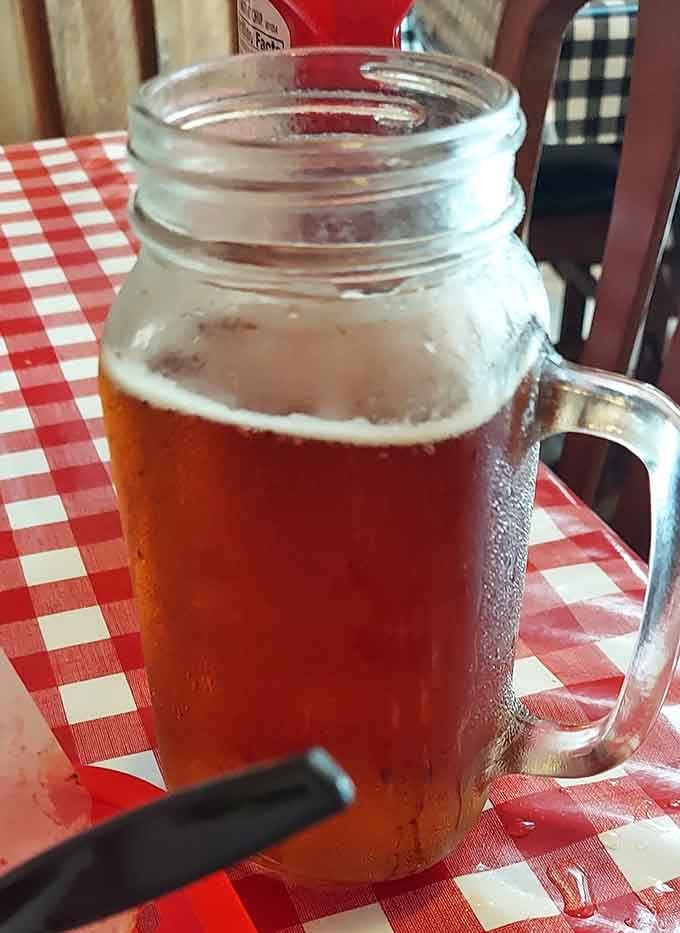 Cold drink in a mason jar on checkered cloth, because some combinations are just meant to be.