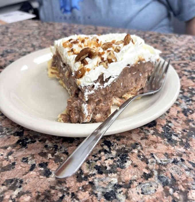 Chocolate cream pie topped with whipped cream and pecans that could end arguments and start new friendships.