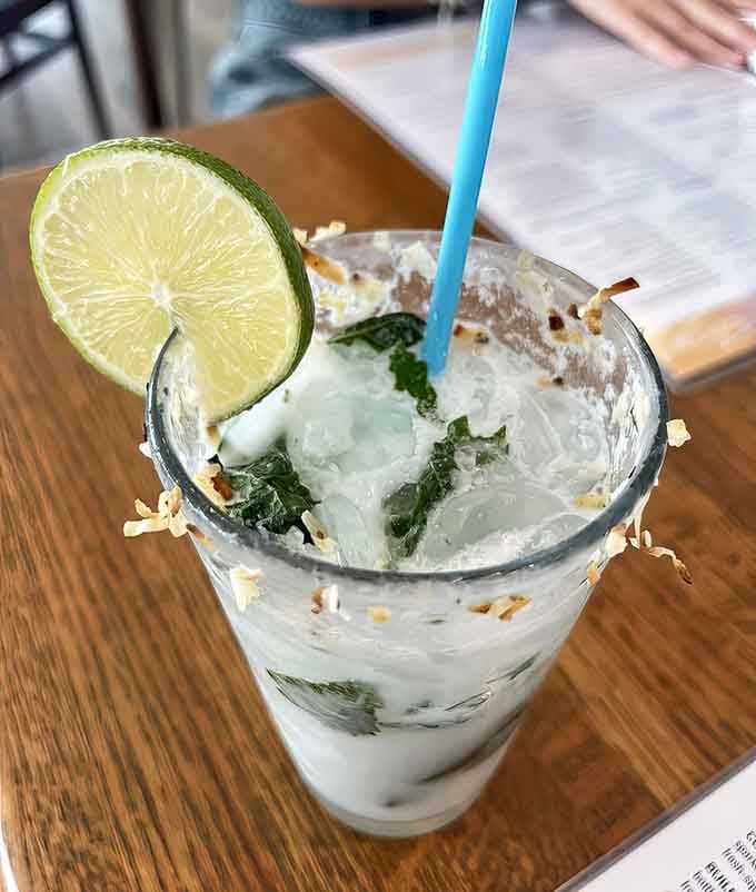 That toasted coconut mojito looks like vacation in a glass, complete with the kind of garnish that photographs beautifully.