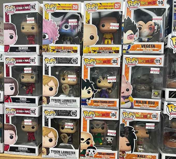 Funko Pop figures stand guard over the shelves, proving that pop culture collectibles belong alongside classic literature perfectly.