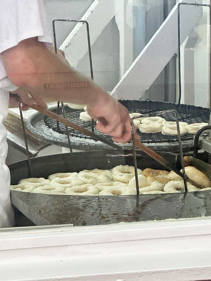 Watch the masters at work, flipping dough in hot oil with the precision of seasoned professionals.