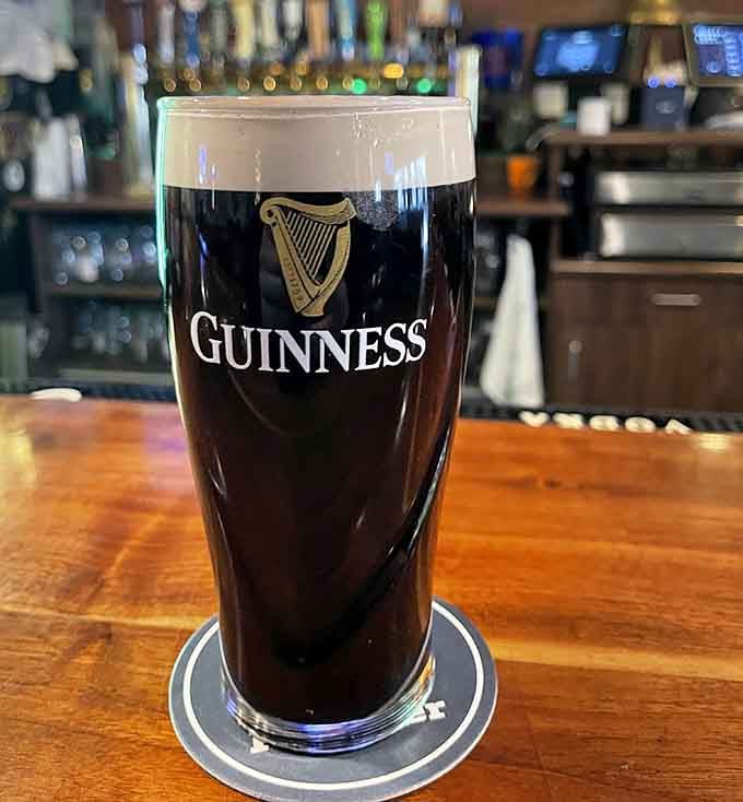 A perfectly poured Guinness with that iconic harp logo, because some things are sacred and shouldn't be rushed.