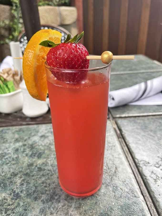 A strawberry hibiscus mimosa garnished with fresh fruit makes day drinking look absolutely respectable and refreshing.