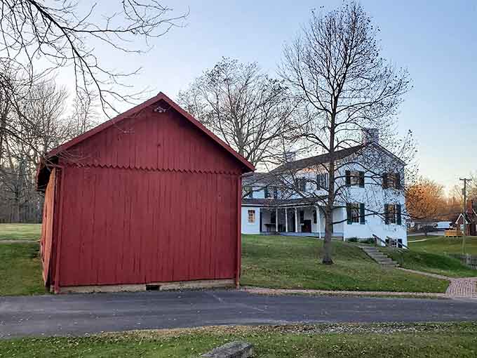 The red barn and white farmhouse create a scene so quintessentially American, you can practically hear the history whispering.
