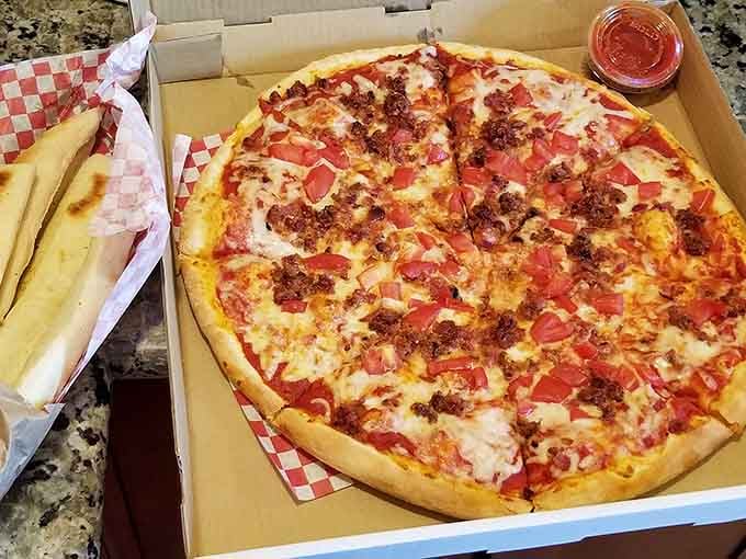 Bacon and fresh tomatoes top this round beauty, because sometimes simplicity is the ultimate sophistication in pizza form.