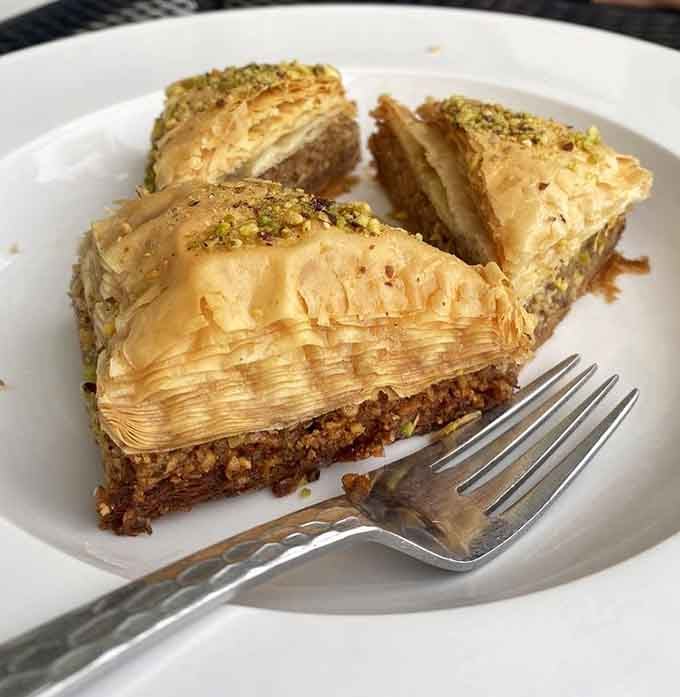 Golden baklava layers flaky phyllo pastry with nuts and honey, creating the kind of sweetness that makes everything else seem irrelevant.