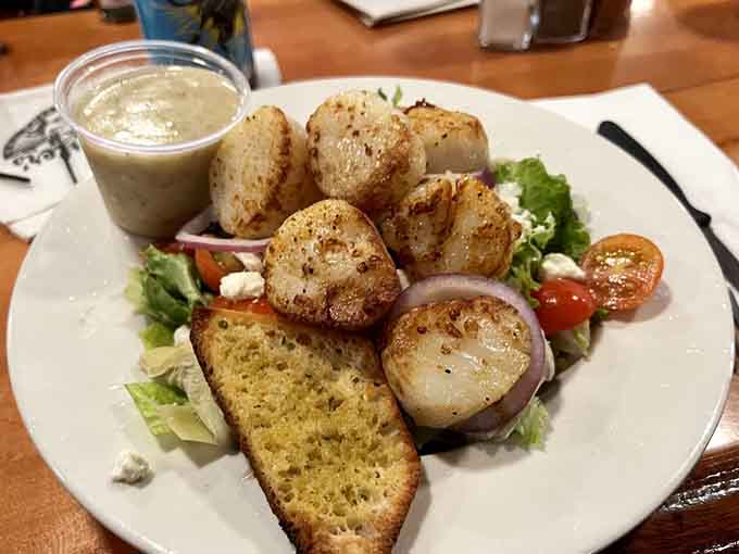 Perfectly seared scallops proving that sometimes the simplest preparations create the most memorable meals on your plate.