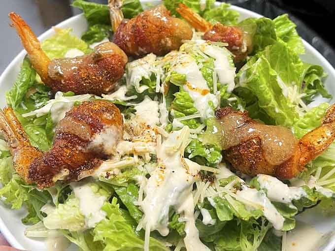 Caesar salad gets a coastal upgrade with perfectly seasoned shrimp that make lettuce feel like a celebration.