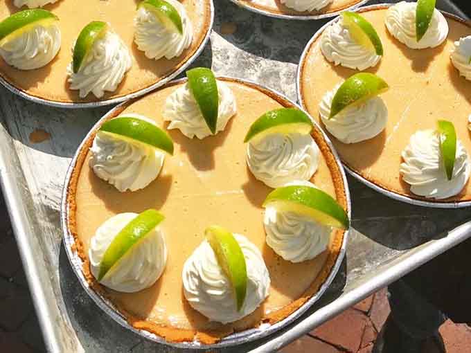 Key lime pie topped with whipped cream rosettes that look almost too pretty to eat. Almost being the key word.