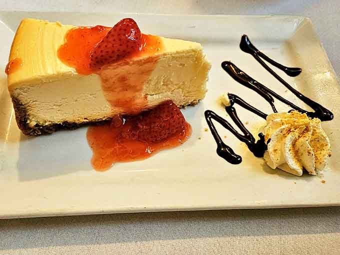 Creamy cheesecake with berry sauce: the sweet ending your meal deserves after all that savory goodness.