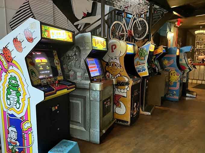 Vintage arcade cabinets lined up like old friends waiting to take your quarters and your dignity, in that order.