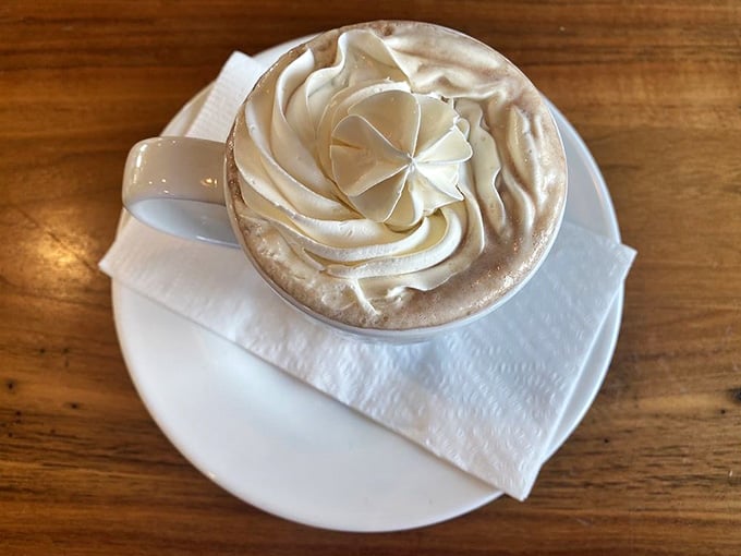 Hot chocolate crowned with whipped cream peaks that belong in a dessert museum, not just breakfast.