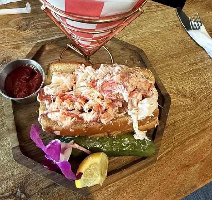 That lobster roll is so generously stuffed, it looks like the bun is barely containing its excitement about all that sweet meat.