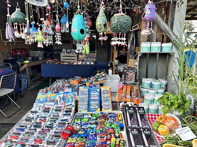 Colorful wind chimes and garden treasures dangling overhead, turning ordinary yard decor into an outdoor art gallery experience.