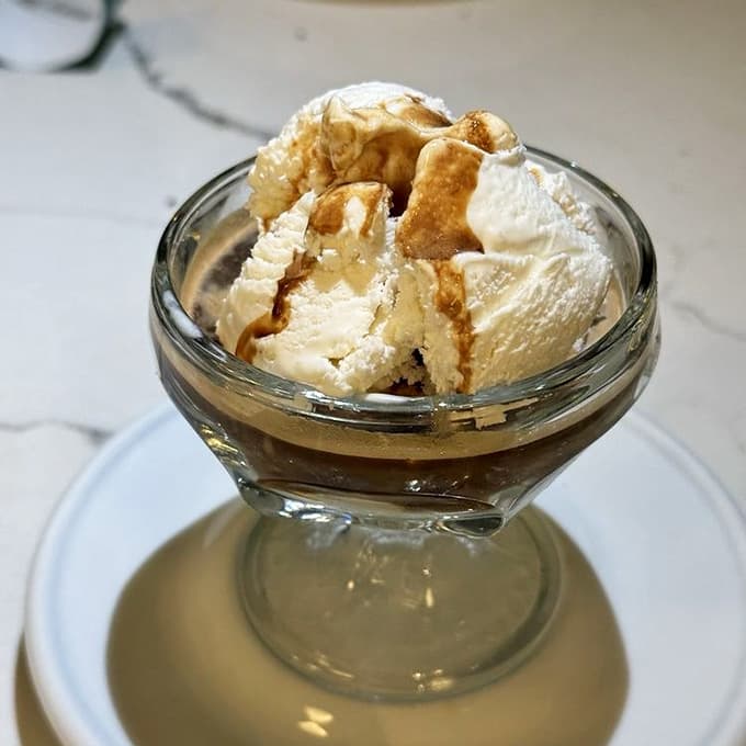 Affogato served simply in a classic glass dish, where hot espresso meets cold gelato in perfect harmony.