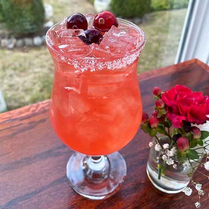 This cranberry-topped cocktail looks refreshingly festive, like summer vacation decided to jump into a glass and stay awhile.