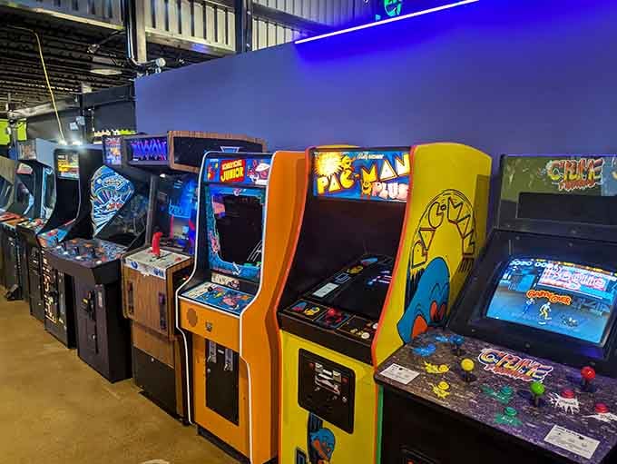 Classic cabinets lined up like old friends waiting to remind you that orange Pac-Man cabinets never go out of style.