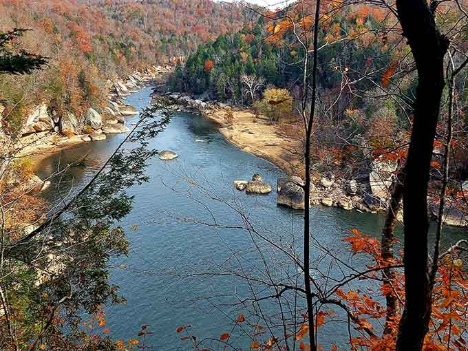 Autumn transforms the Cumberland River into a painter's palette, with fiery foliage reflecting off water that's seen centuries pass by.