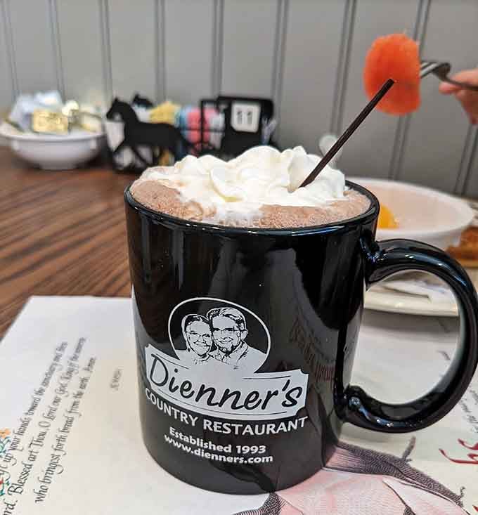 Hot chocolate topped with whipped cream and a festive stirrer&mdash;because even comfort food restaurants understand the importance of presentation.