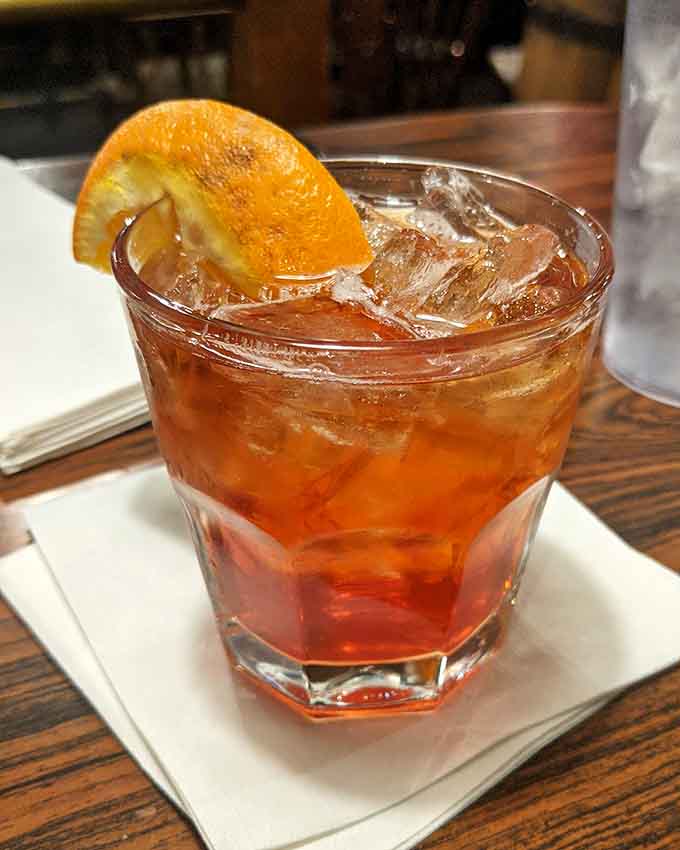 An Old Fashioned garnished with orange, proving even cowboys appreciate a touch of citrus sophistication occasionally.