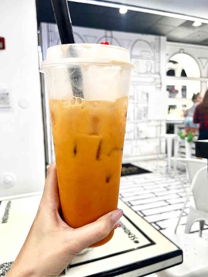 Thai iced tea providing the only splash of color you need in this monochromatic masterpiece of a restaurant.