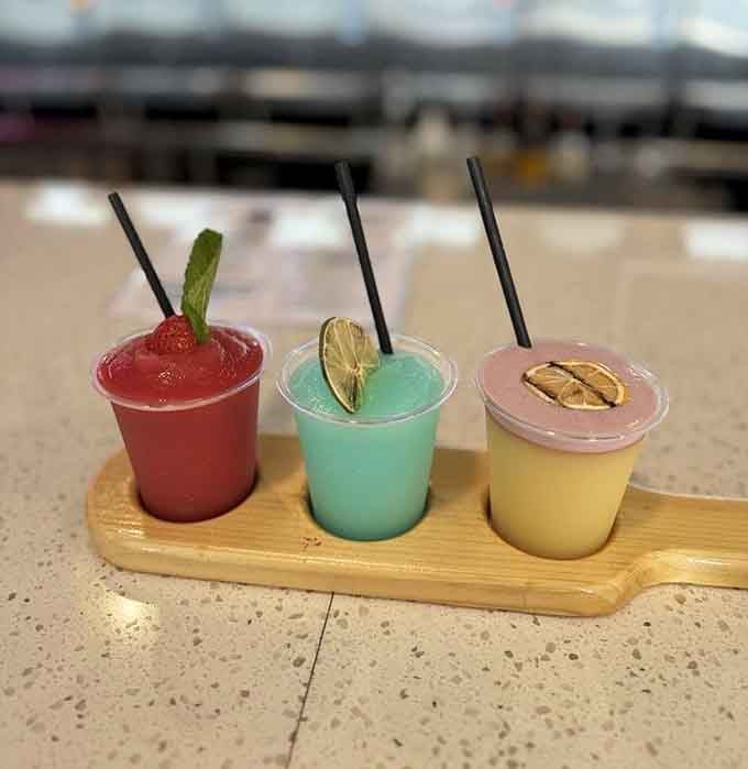 A slushy flight that looks like liquid sunshine and tastes like summer vacation in three perfect flavors.