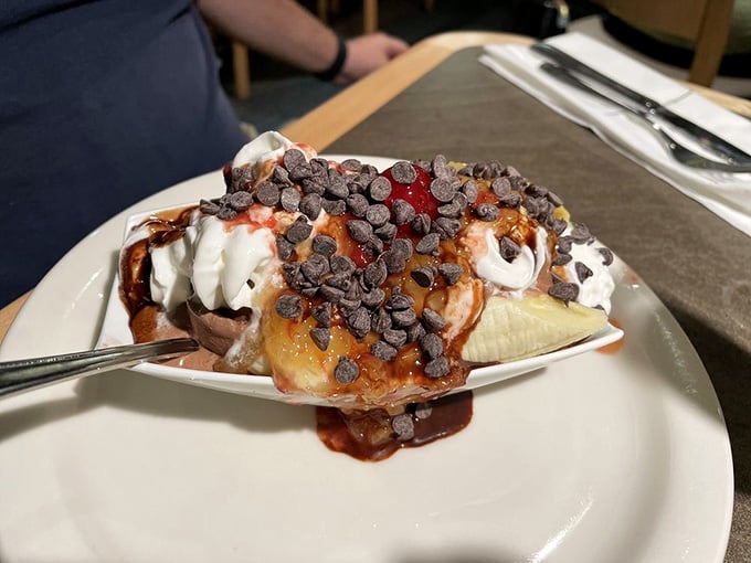 This banana split creation topped with chocolate chips represents everything right about unlimited dessert access and poor decisions.