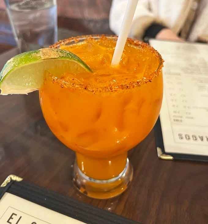 That chili-lime rim and gorgeous orange hue signal one thing: this margarita means serious business in the best way.