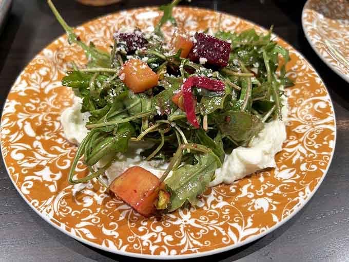 Arugula, roasted beets, and creamy ricotta on a gorgeous patterned plate that's almost too pretty to eat.