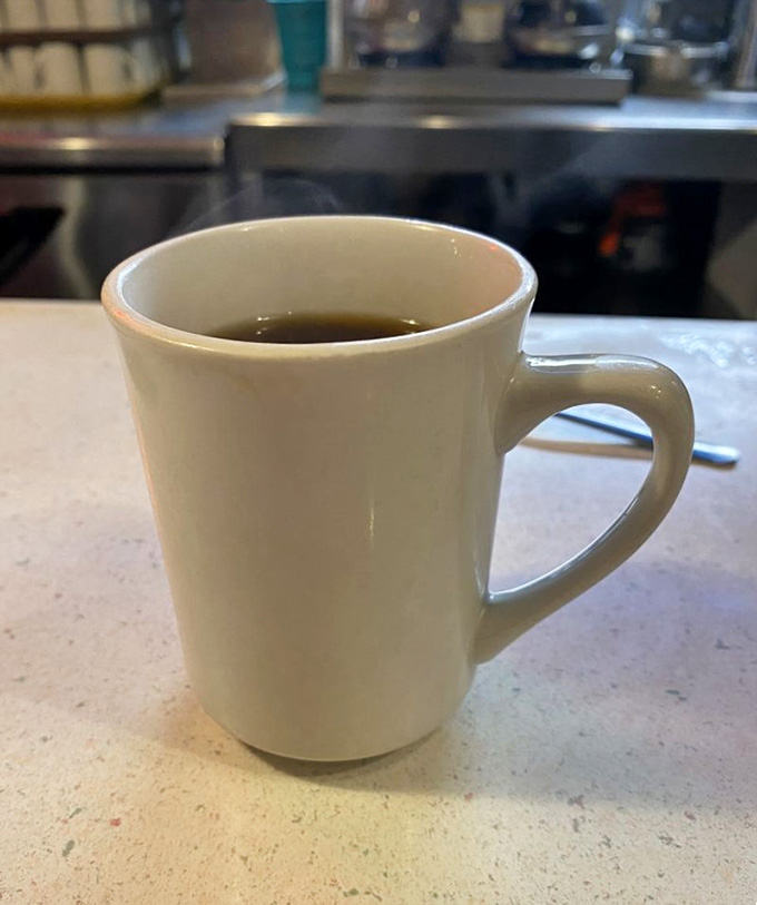 Simple coffee in a classic mug, refilled endlessly by servers who actually care about your caffeine needs.