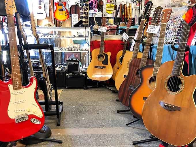 Acoustic and electric guitars line up like old friends, waiting for the right musician to take them home.