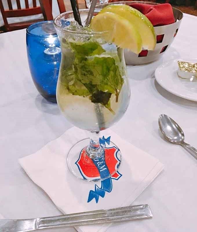 A mojito so refreshing it practically whispers "you deserve this" while you wait for your massive steak.