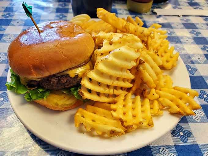 A juicy burger paired with waffle fries proves that sometimes the grill menu deserves just as much attention.