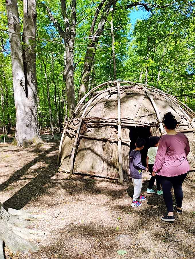 Young explorers discover how indigenous peoples lived here centuries ago, making history tangible through this traditional bark dwelling structure.