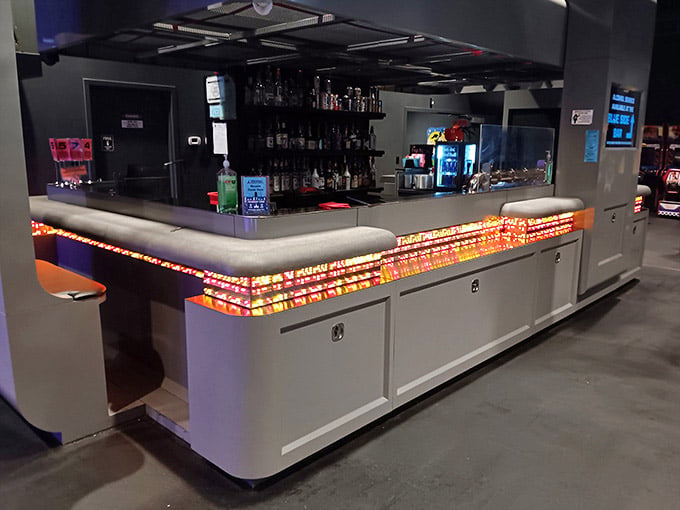 A bar lit up like a pinball machine's bonus round, where craft beer meets the glow of pure retro ambition.