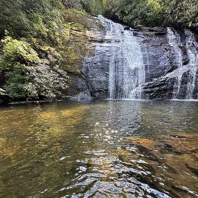 The natural pool at the base invites contemplation, photography, and possibly some serious life reflection about moving here.