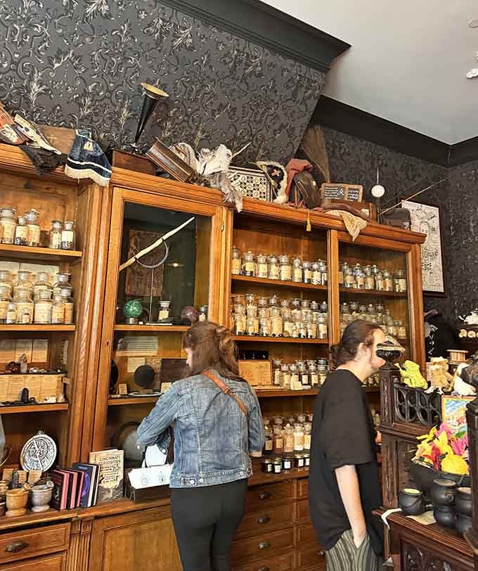 Real shoppers browsing real magic, surrounded by antique cabinets filled with herbs that would make any herbalist swoon.
