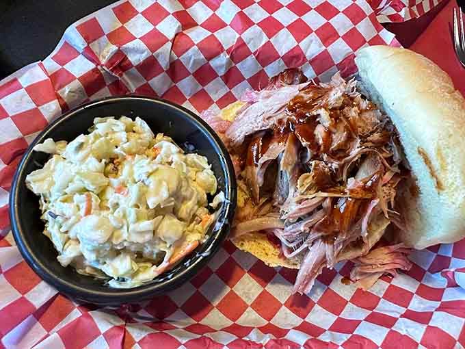Hand-pulled pork piled high on a soft roll with tangy coleslaw is sandwich architecture at its finest.