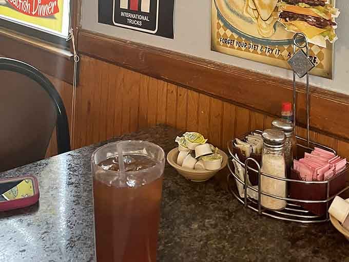 Sweet tea waiting patiently alongside the condiments, ready to make your meal complete in true diner fashion.