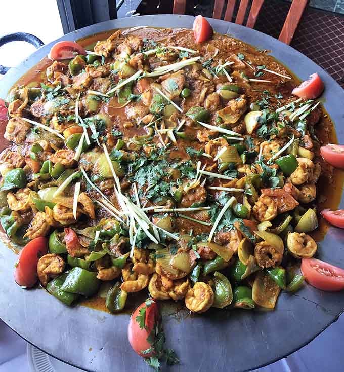 Kadhai shrimp loaded with peppers and spices on a sizzling platter that announces your excellent decision-making to the entire restaurant.