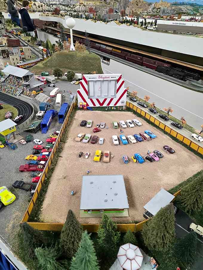 A miniature drive-in theater complete with tiny moviegoers enjoying films under stars that never actually twinkle.