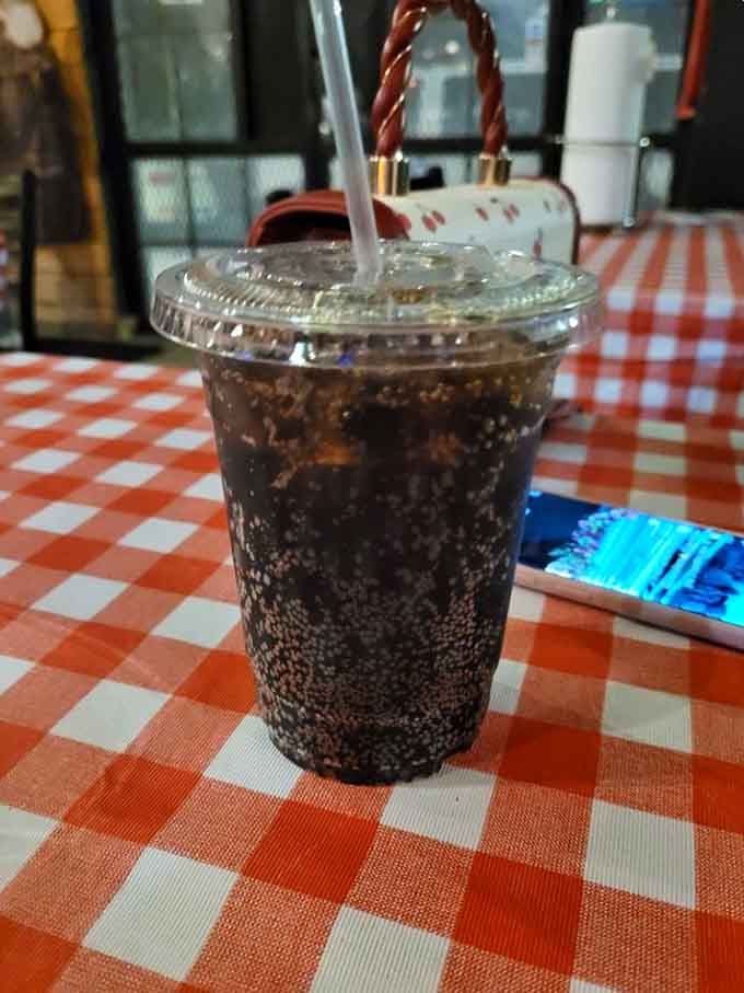 Sometimes the best pairing for smoky barbecue is an ice-cold soda on a classic checkered tablecloth, simple as that.