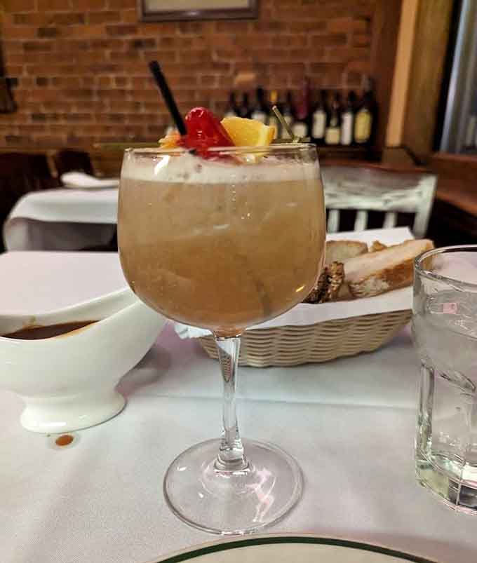 A well-crafted cocktail with a cherry and lemon garnish, because great steak deserves equally great company in a glass.