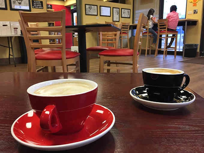 Bold red cups serving up lattes that'll power you through your next comic book marathon with caffeinated determination.