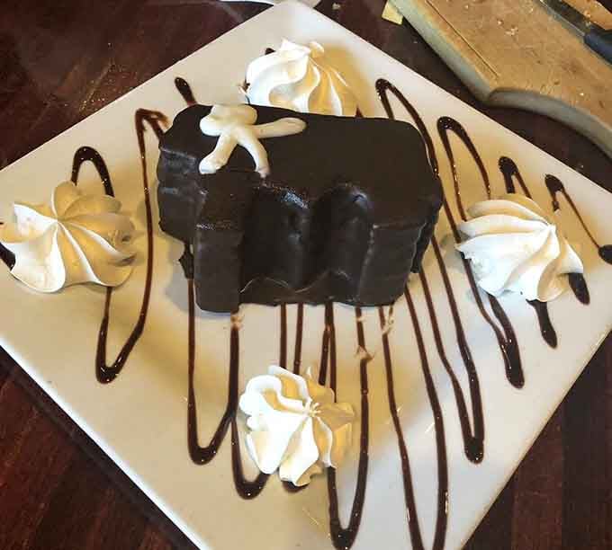 Chocolate dessert with artistic drizzle and whipped cream rosettes makes saying yes to dessert incredibly easy.