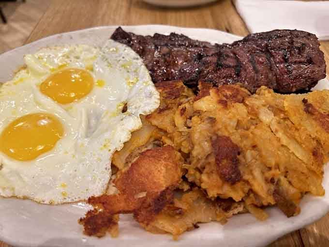 Steak, eggs, and latkes walk into a plate together; this is no joke, just breakfast perfection.