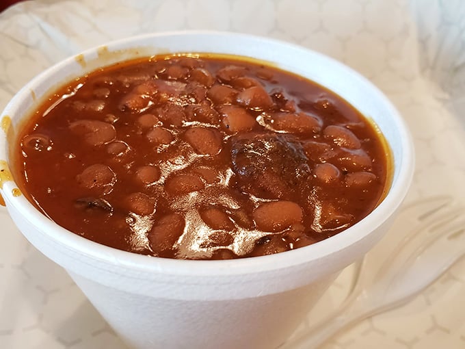 Baked beans swimming in sauce, ready to complement whatever smoked meat you've chosen as your main event.